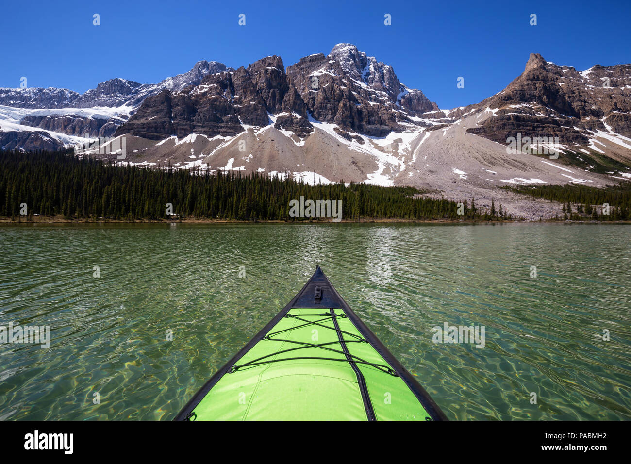 Kayaking in a glacier lake during a vibrant sunny summer day. Taken in ...