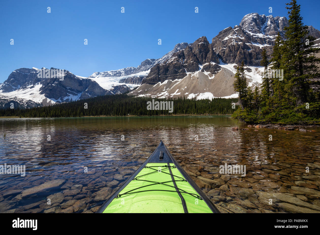 Kayaking in a glacier lake during a vibrant sunny summer day. Taken in ...