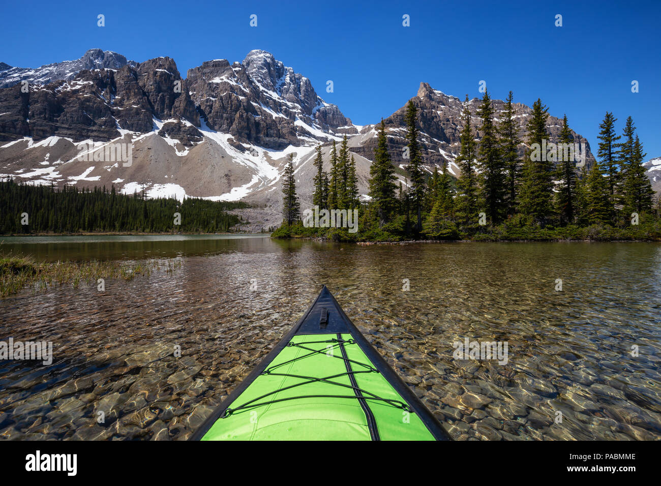 Kayaking in a glacier lake during a vibrant sunny summer day. Taken in ...