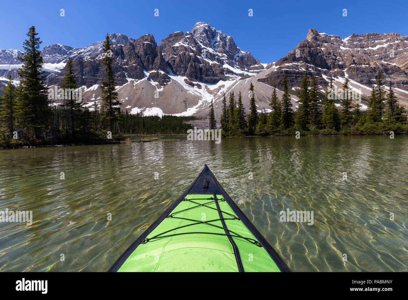 Kayaking in a glacier lake during a vibrant sunny summer day. Taken in ...
