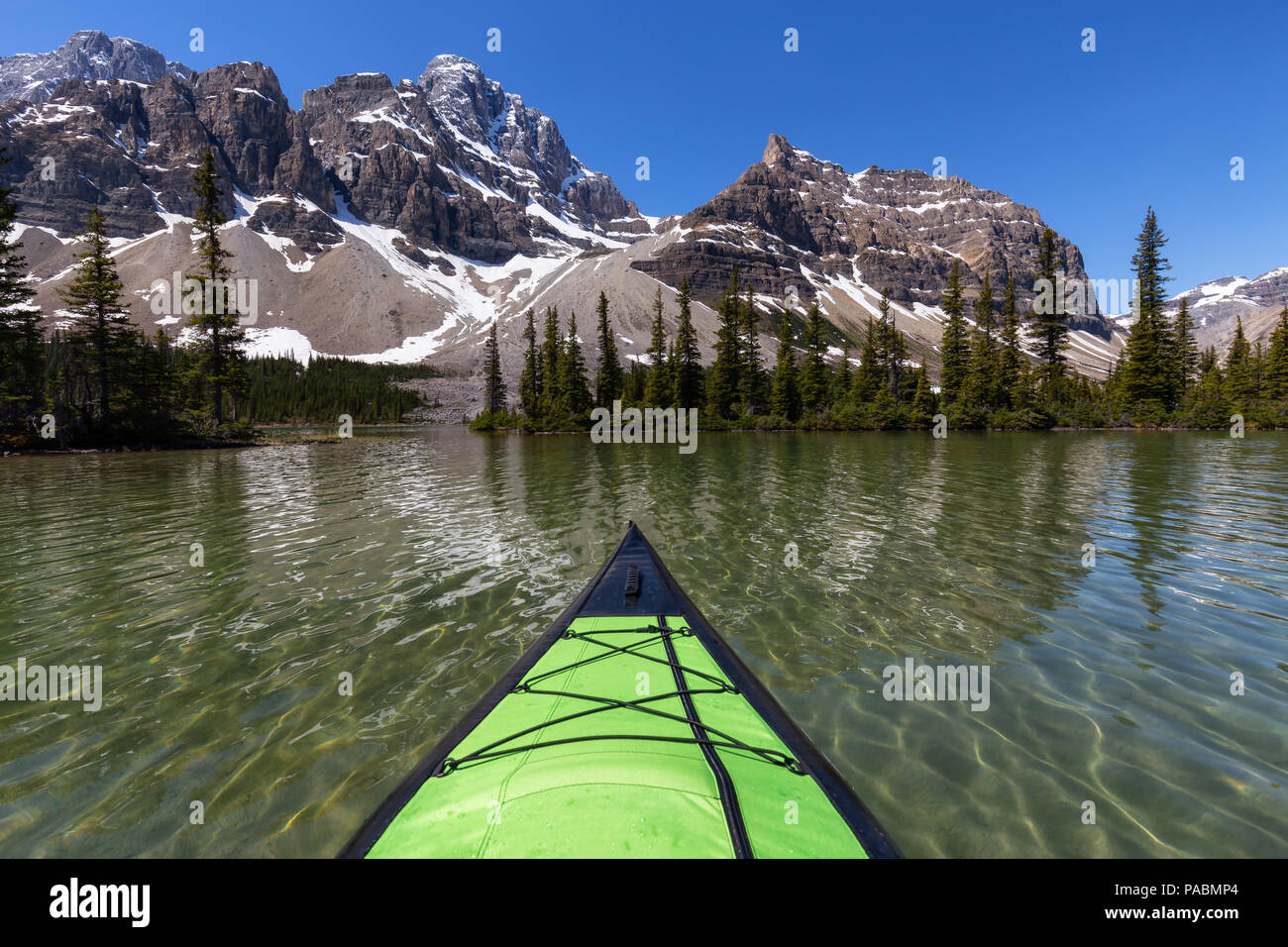 Kayaking in a glacier lake during a vibrant sunny summer day. Taken in ...