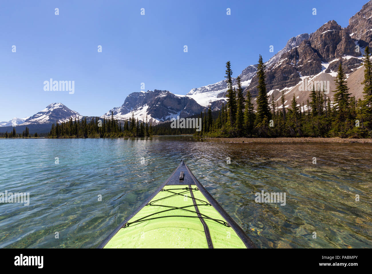 Kayaking in a glacier lake during a vibrant sunny summer day. Taken in ...