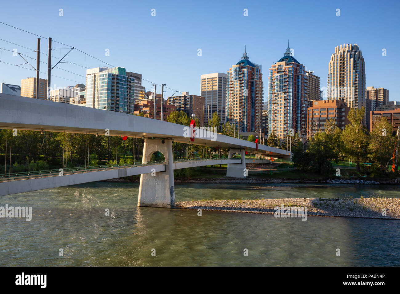 Bridge across Bow River during a vibrant summer sunrise. Taken in ...