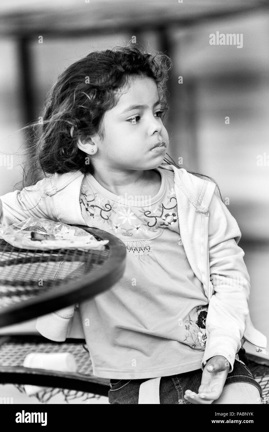SAN JOSE, COSTA RICA - JAN 6, 2012: Unidentified Costa Rican girl sits ...