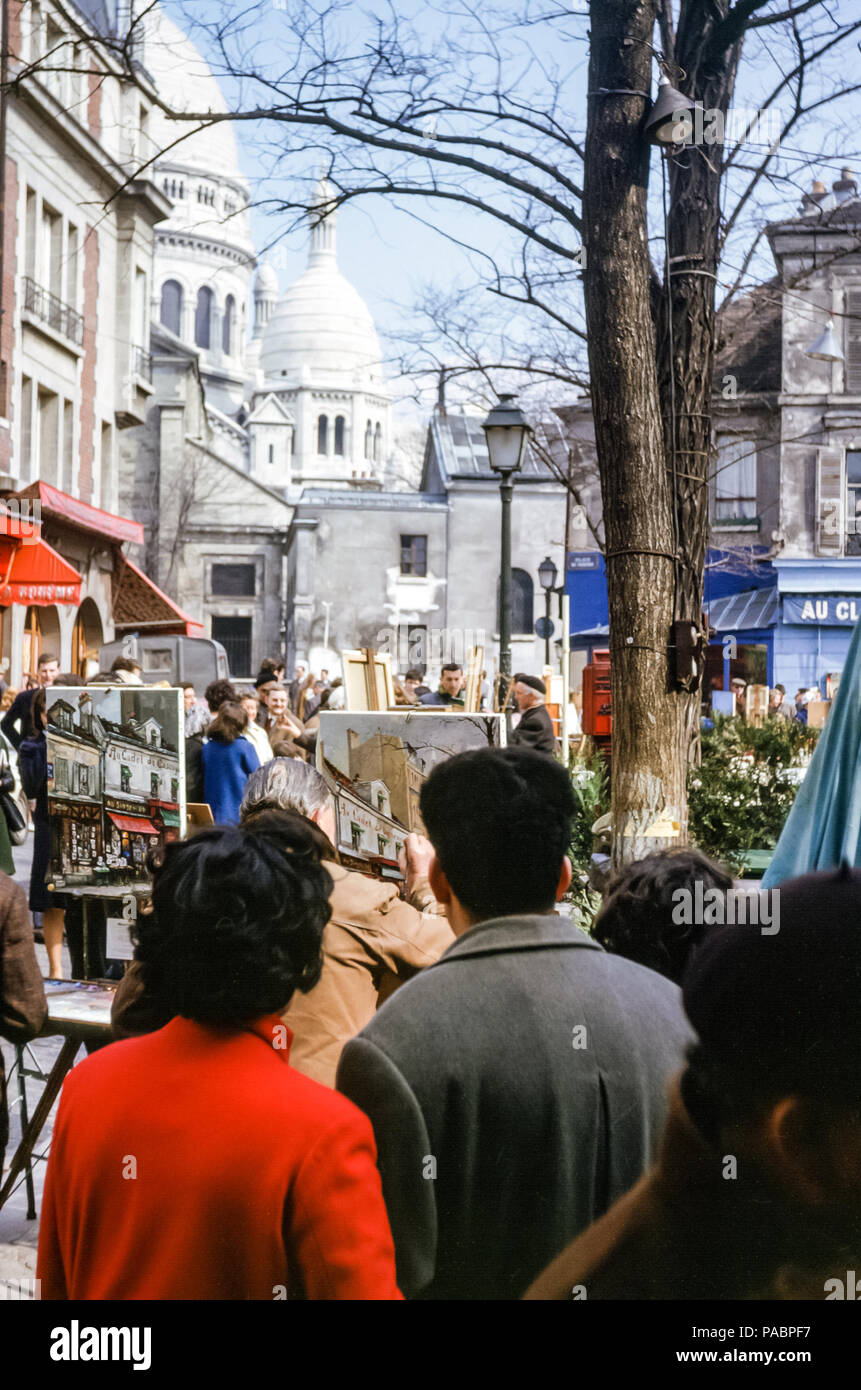 Crowded street scene with a couple watching artists at work painting ...