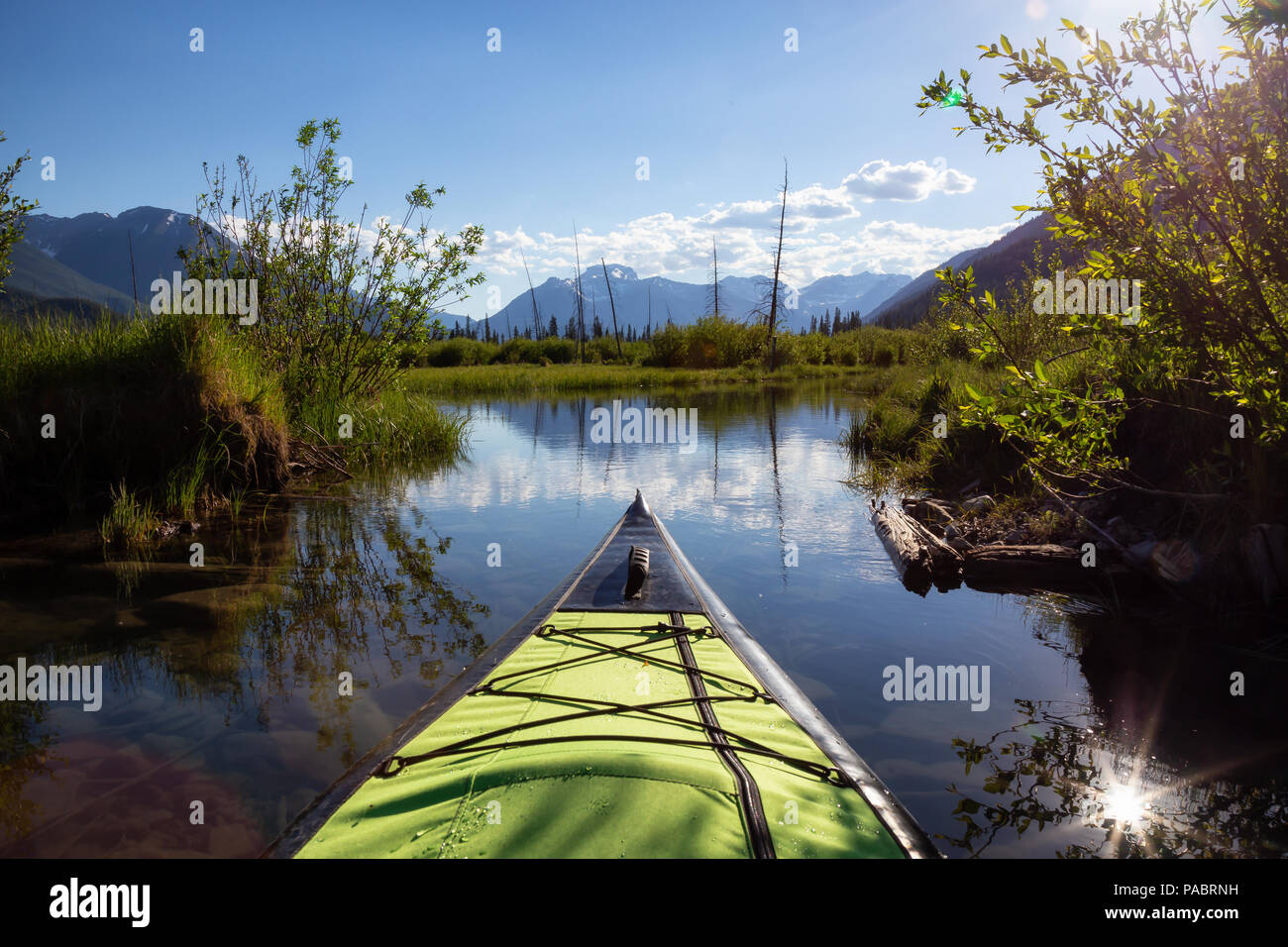 Kayaking in a beautiful lake surrounded by the Canadian Nature ...