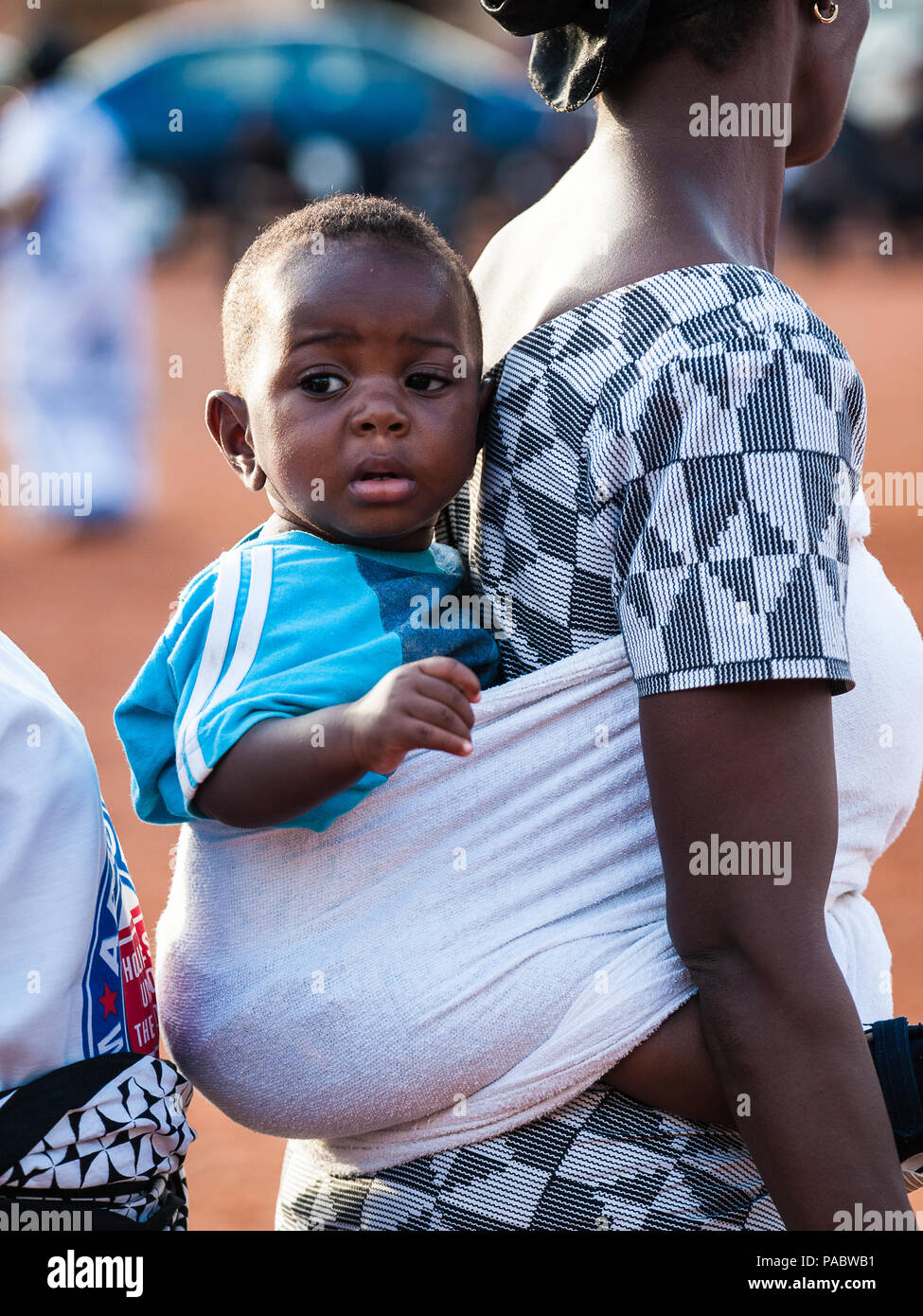 ACCRA, GHANA - MARCH 4, 2012: Unidentified Ghanaian baby on his mother ...