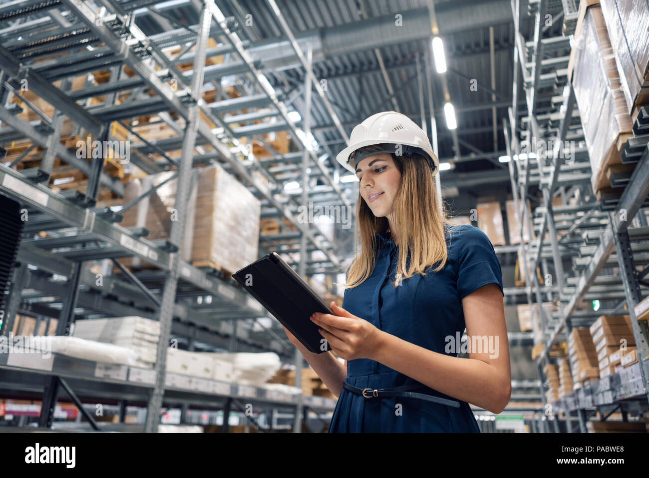 Beautiful young woman worker of furniture store in shopping center ...