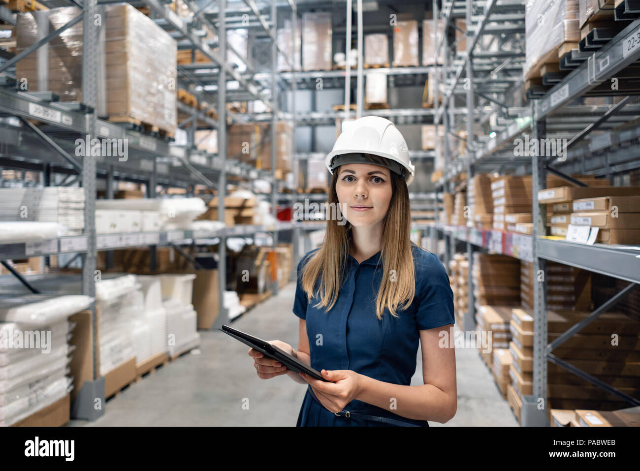 Beautiful young woman worker of furniture store in shopping center ...