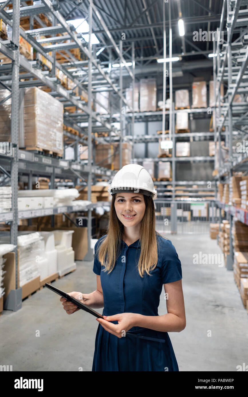 Beautiful young woman worker of furniture store in shopping center ...