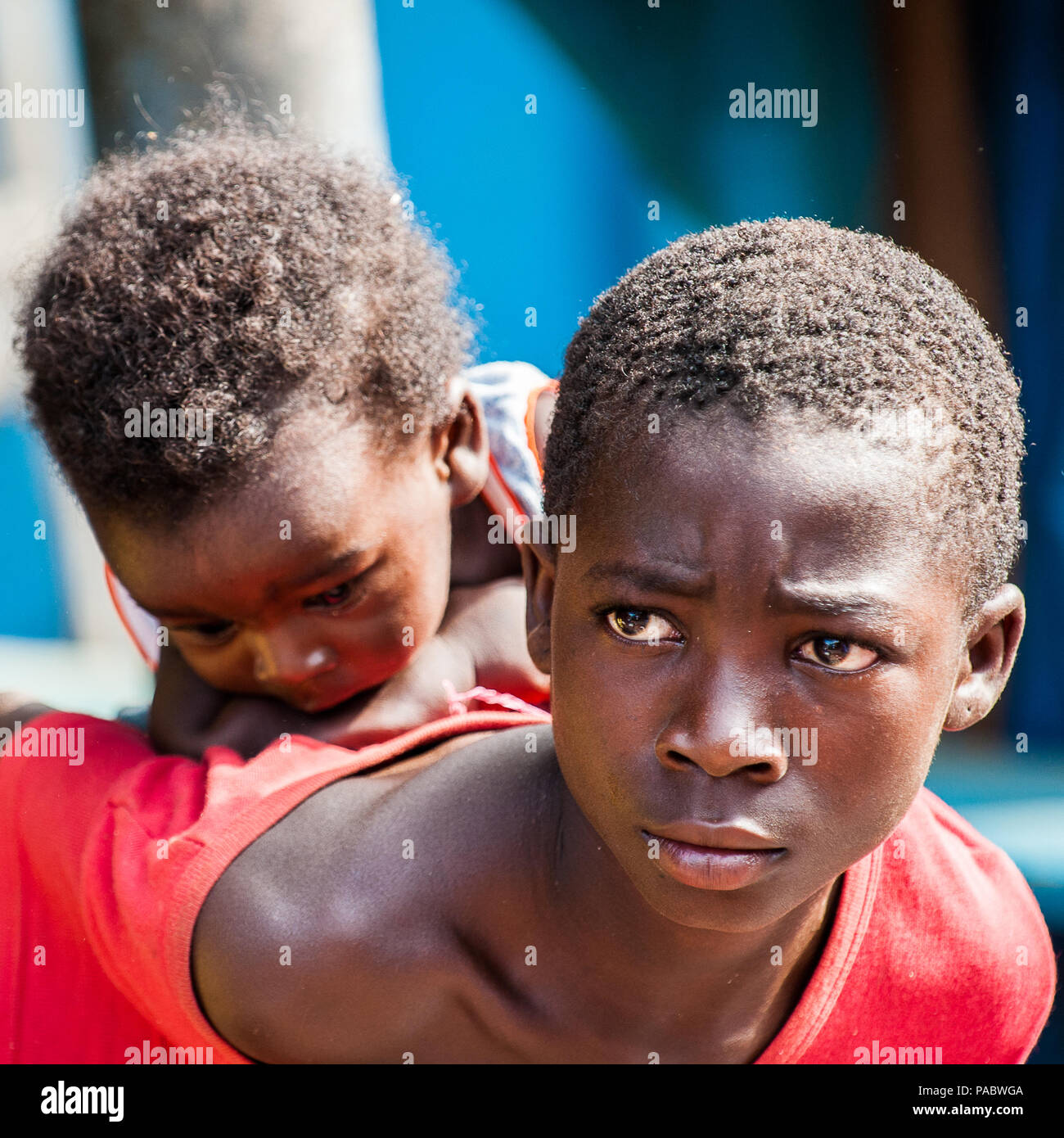 ACCRA, GHANA - MARCH 4, 2012: Unidentified Ghanaian boy carries his ...