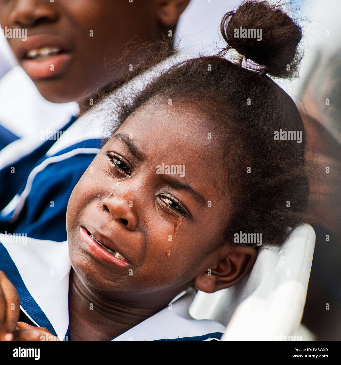 ACCRA, GHANA - MARCH 4, 2012: Unidentified Ghanaian girl cries in a ...