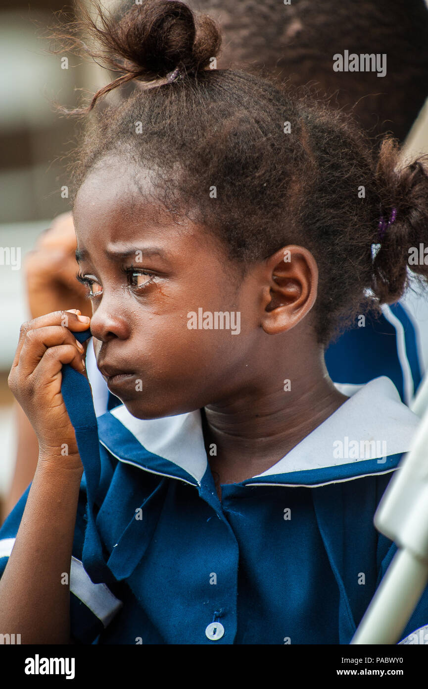 ACCRA, GHANA - MARCH 4, 2012: Unidentified Ghanaian girl cries in a ...