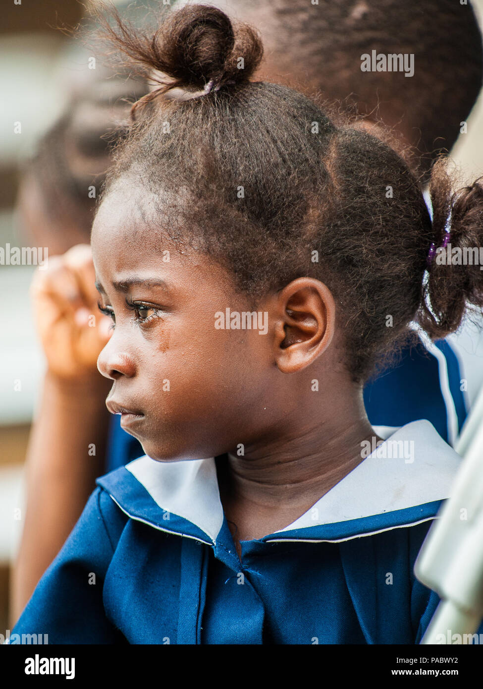 ACCRA, GHANA - MARCH 4, 2012: Unidentified Ghanaian girl cries in a ...