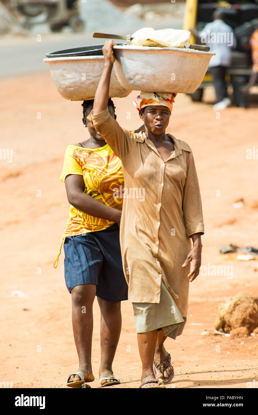ACCRA, GHANA - MARCH 6, 2012: Unidentified Ghanaian women carry buckets ...