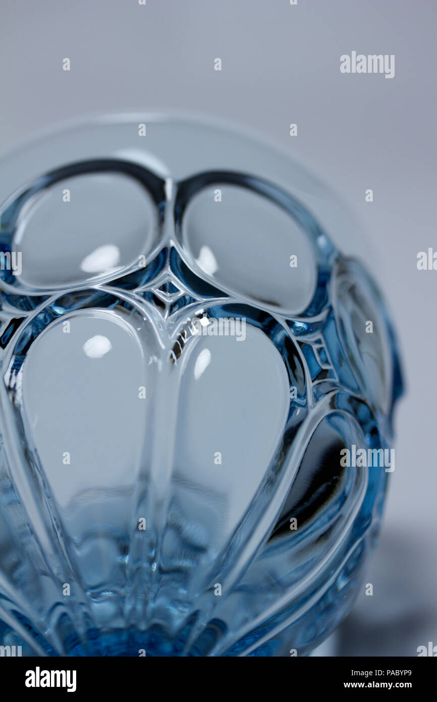 Macro abstract view of a single blue color crystal water or wine goblet ...