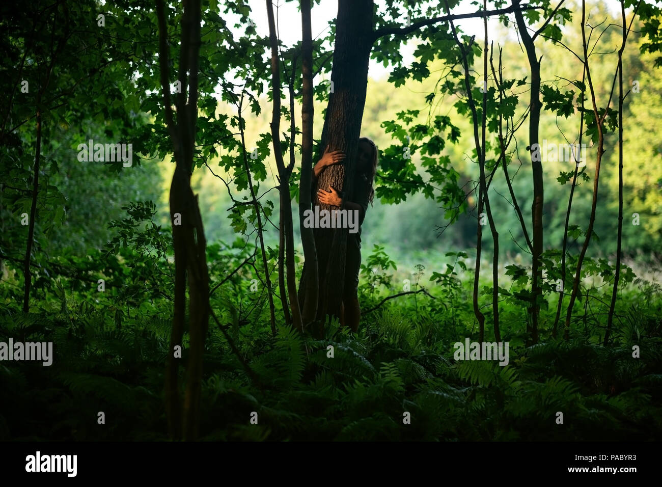 Young girl hiding in woods hi-res stock photography and images - Alamy