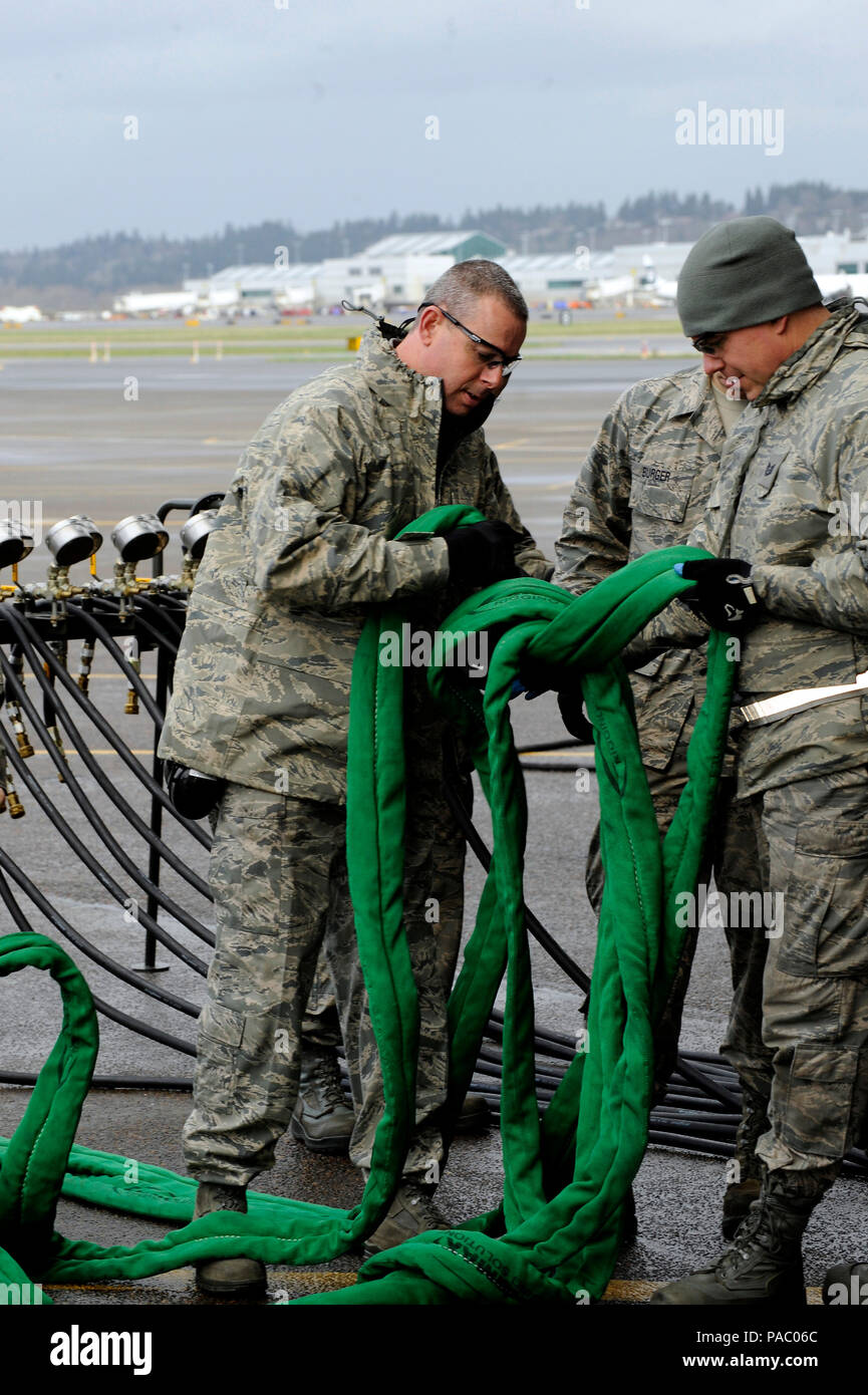 Members of the 142nd Maintenance Group untangle a hose during a Crash ...
