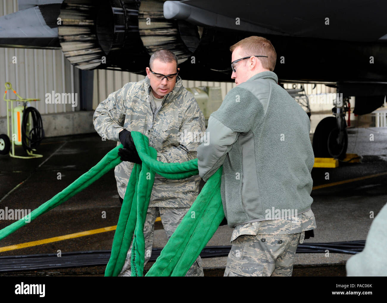 Members of the 142nd Maintenance Group untangle a hose during a Crash ...