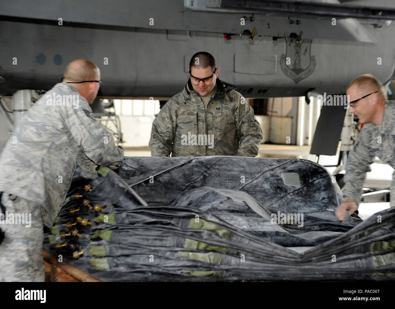 Members of the 142nd Maintenance Group deflate 15-ton modular lift bags ...
