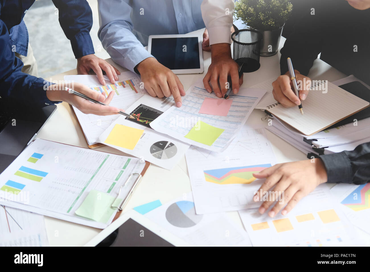 Business meeting with paper chart and laptop computer tablet on table ...