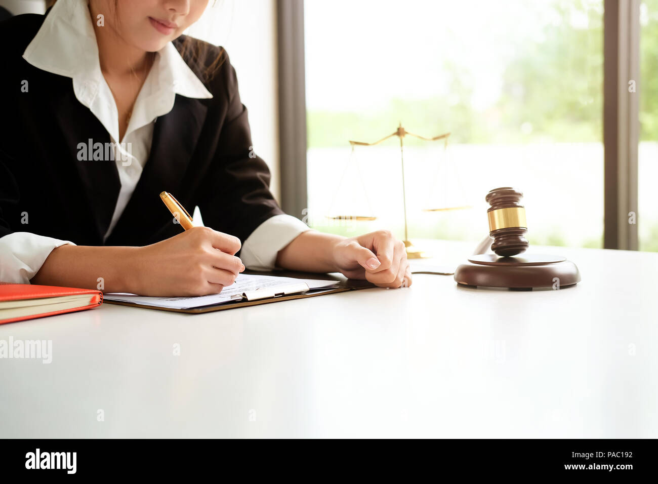 Lawyer woman working on workplace with window light at morning time ...