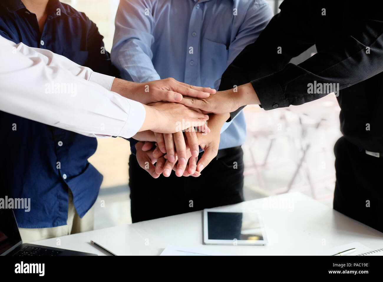 Business team putting their hands together cooperation success business ...
