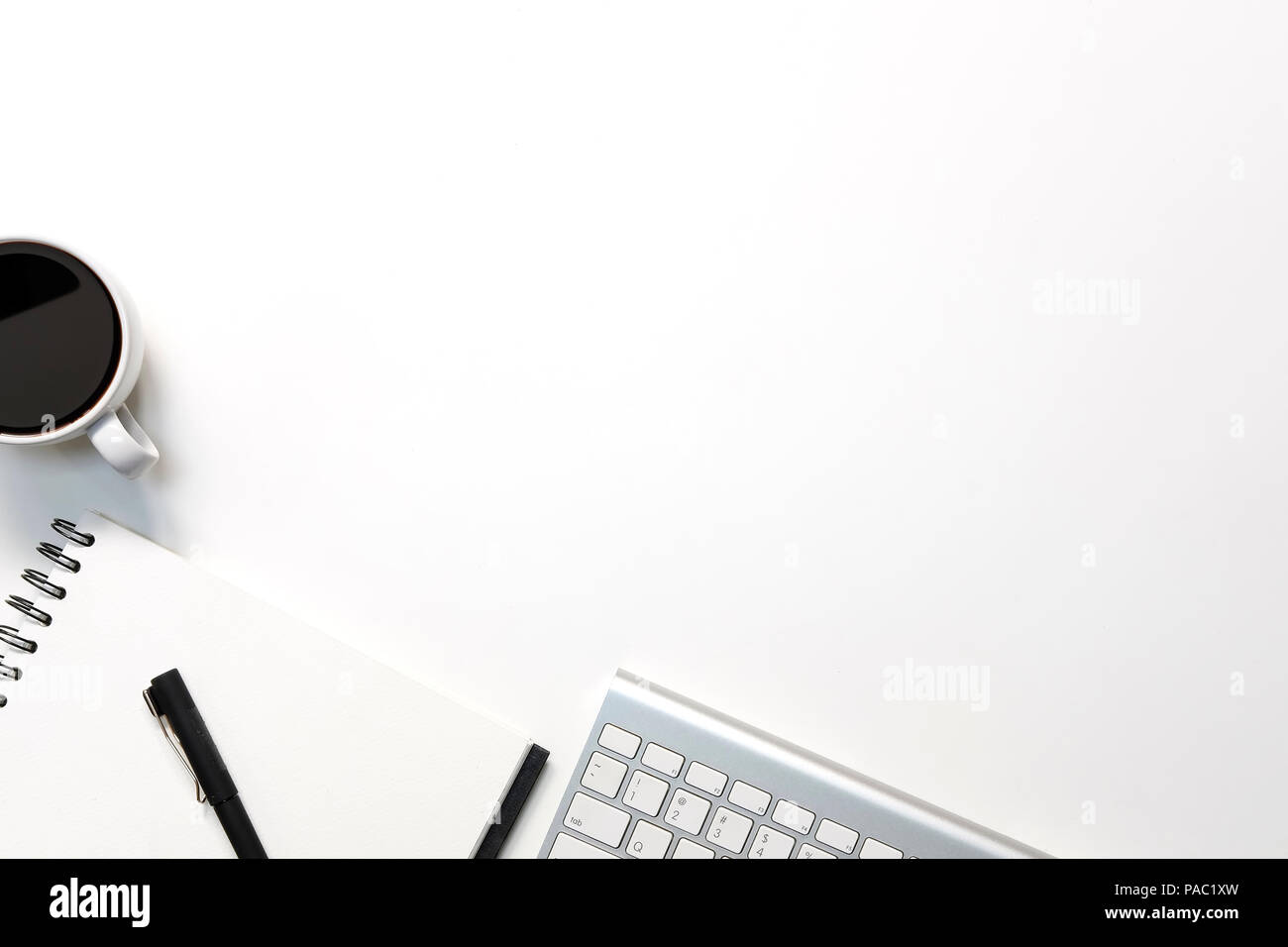 Modern white office desk table with keyboard computer, coffee, pen and ...