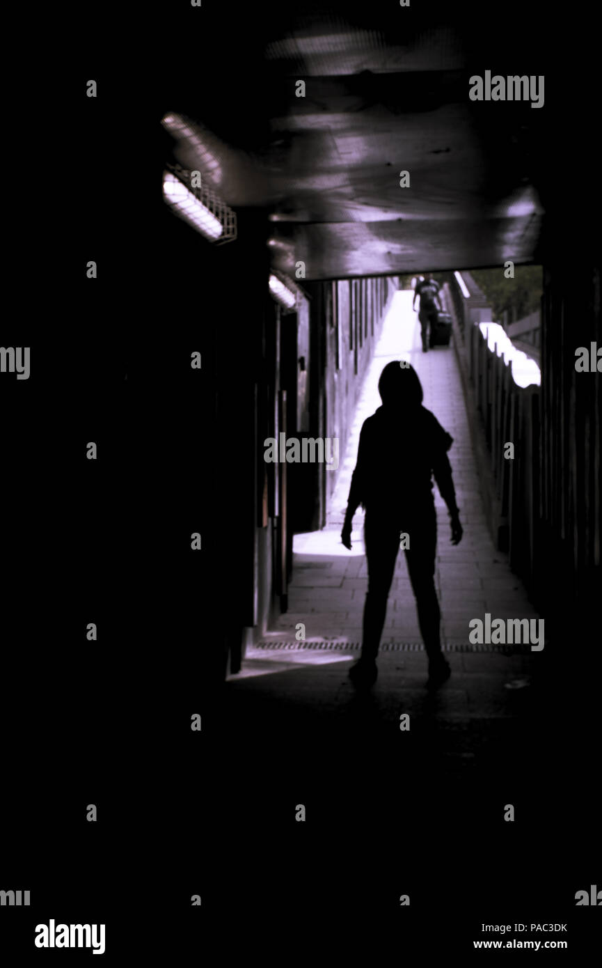 Woman alone and sad in a tunnel. Scene of mystery and desolation Stock ...