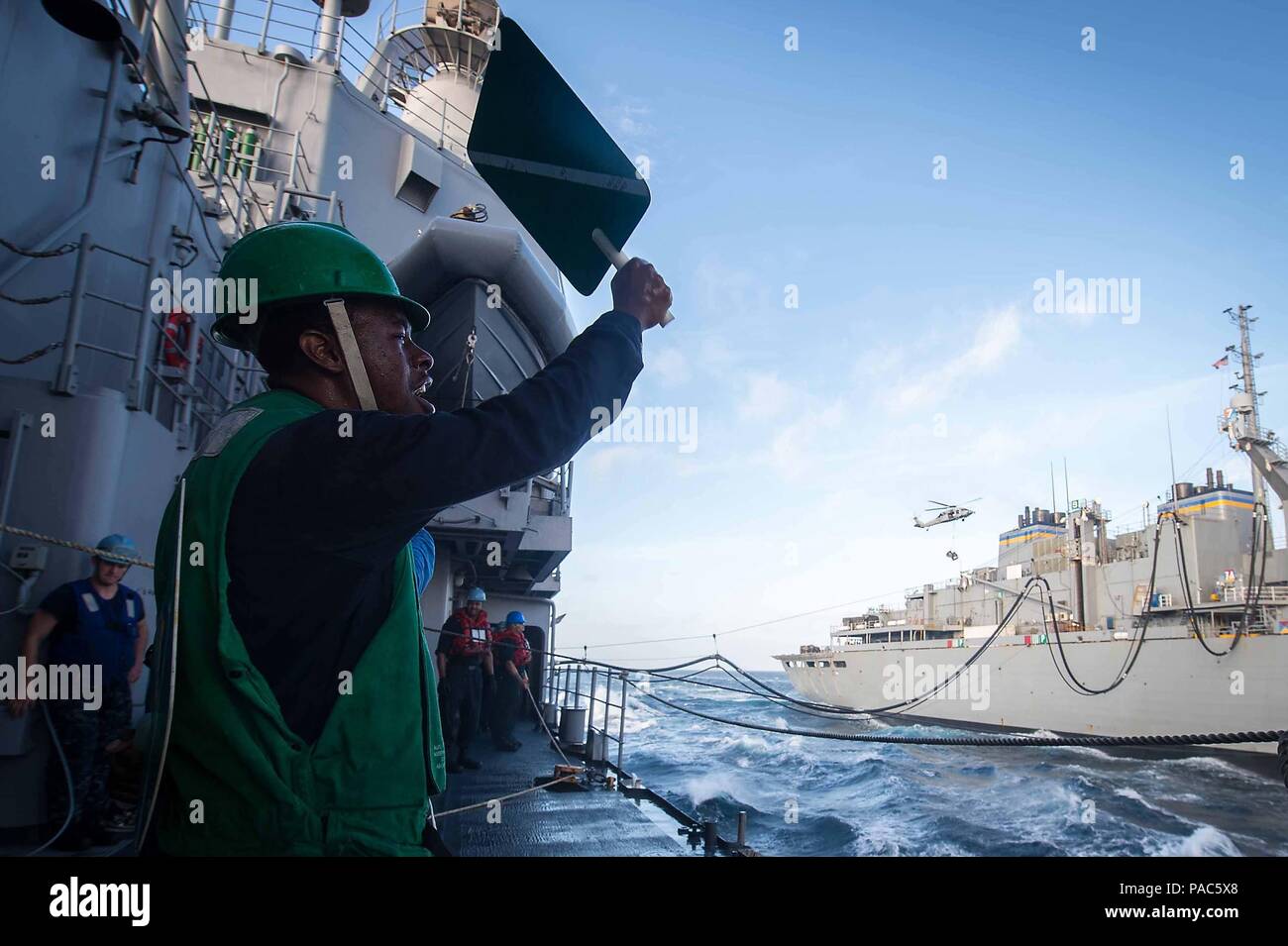 Seaman Recruit signals fast combat support ship USNS Rainier (T-AOE 7 ...