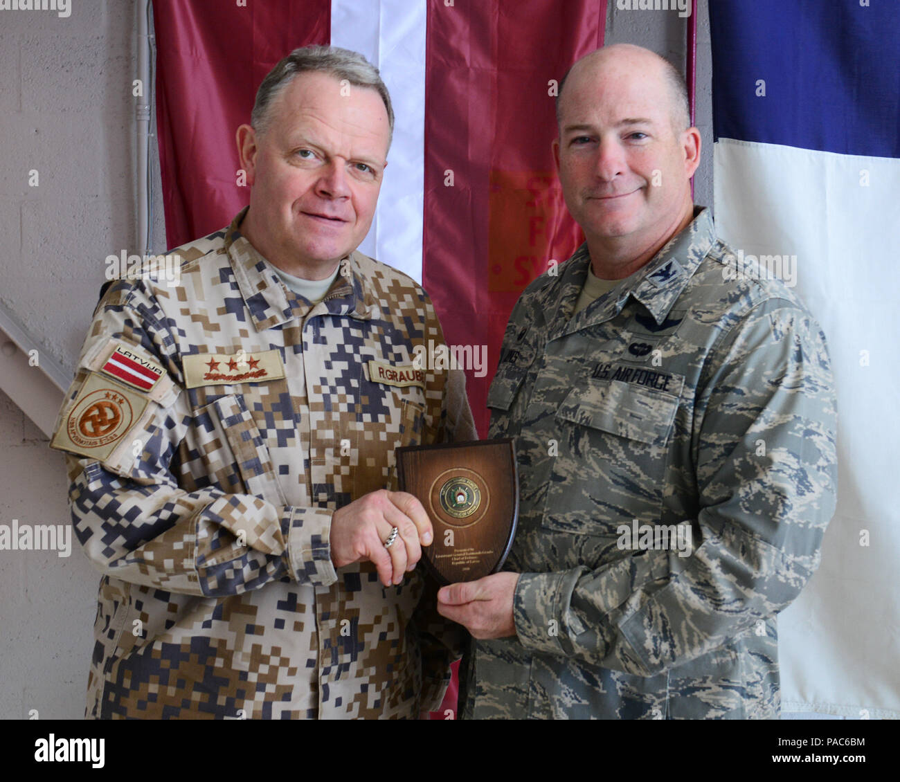 Lt. Gen. Raimonds Graube, Latvian chief of defense, presents Col. Stan ...