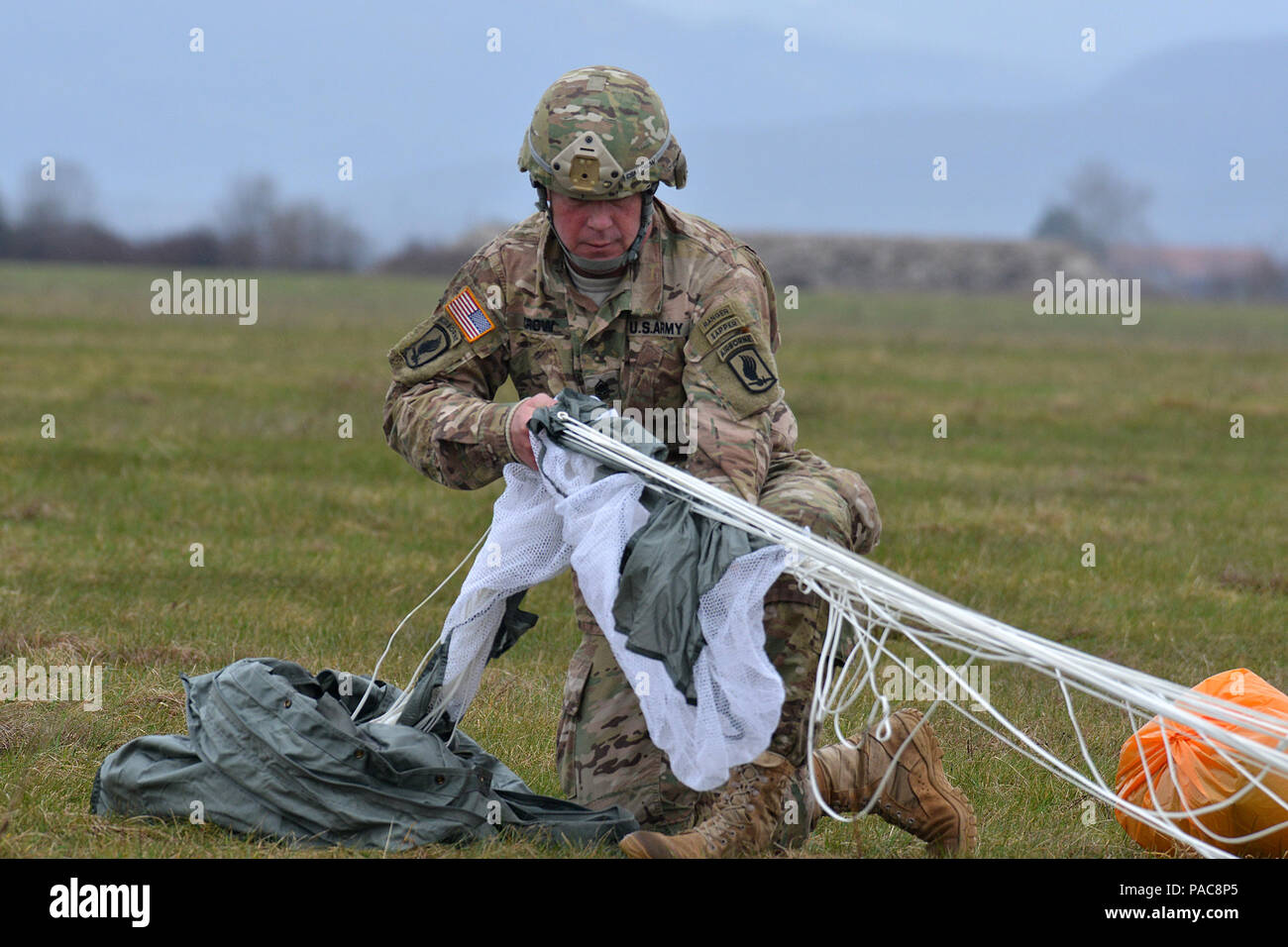 U.S. Army paratrooper, CSM Travis Crow, recover his equipment after ...