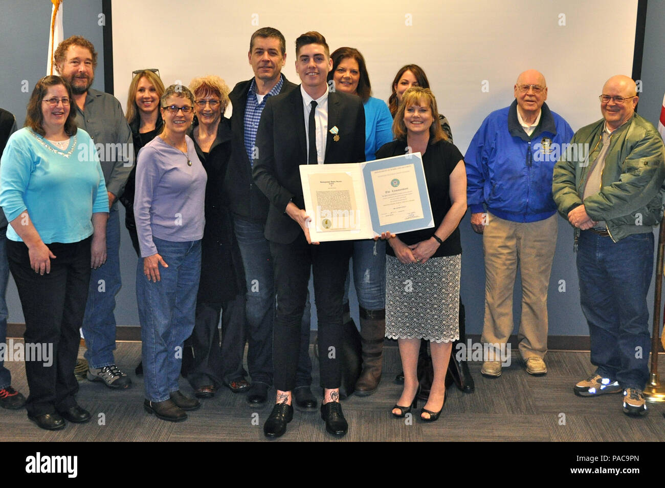 Justin Sweet stands with his family after receiving the Distinguished ...