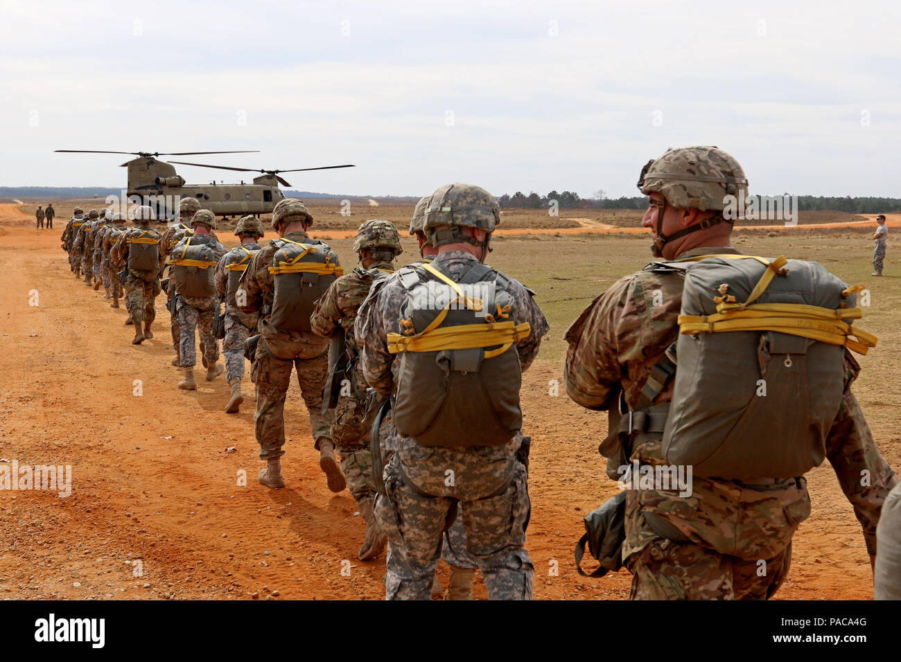 Paratroopers assigned to the 82nd Airborne Division walk out to a Ch-47 ...