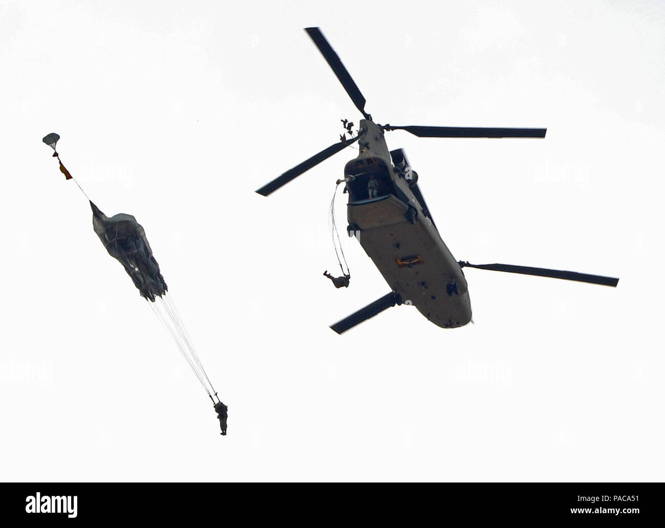 Paratroopers assigned to the 82nd Airborne Division walk off a Ch-47 ...