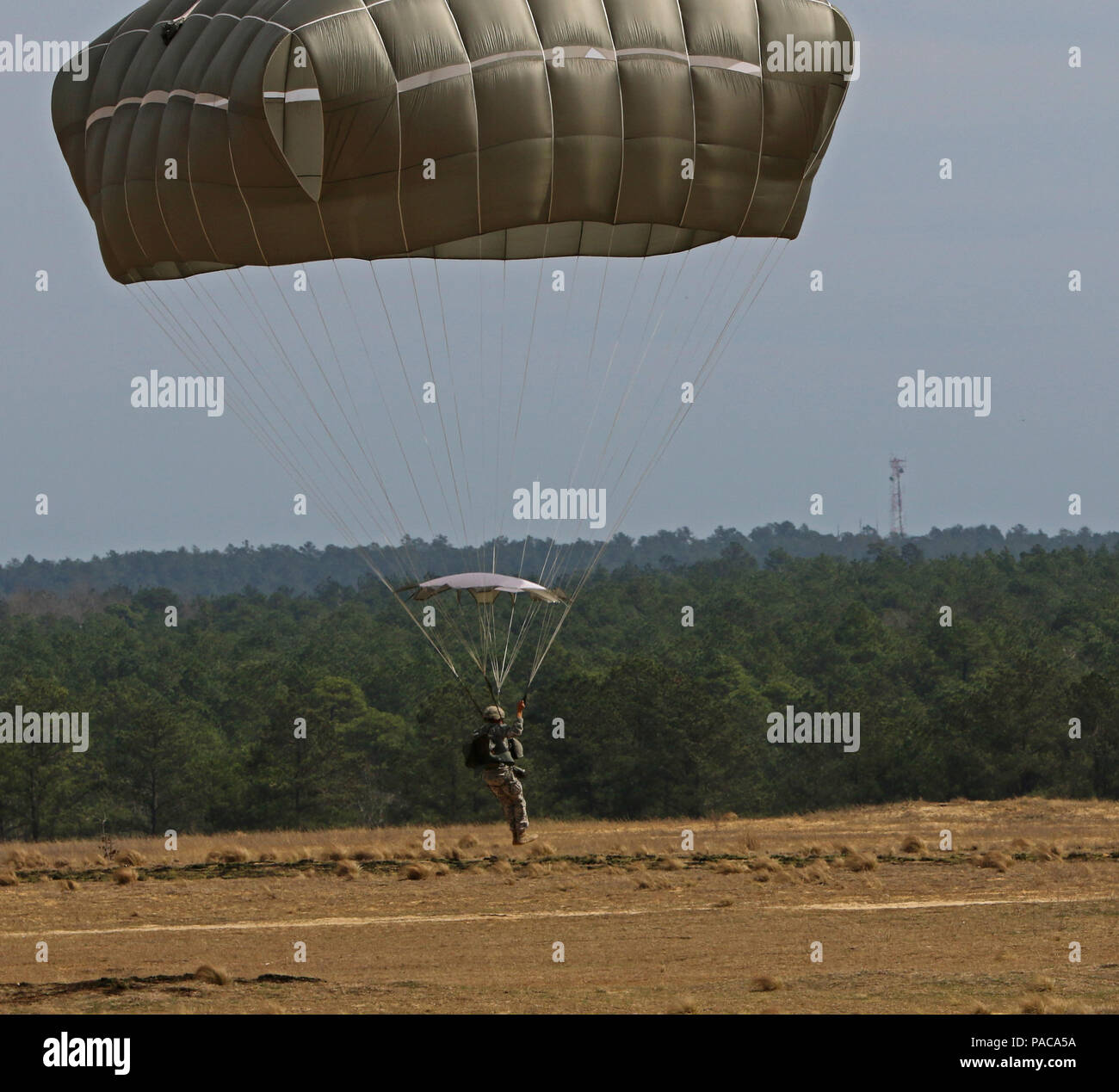 A Paratrooper prepares to land after exiting a Ch-47 Chinook as part of ...