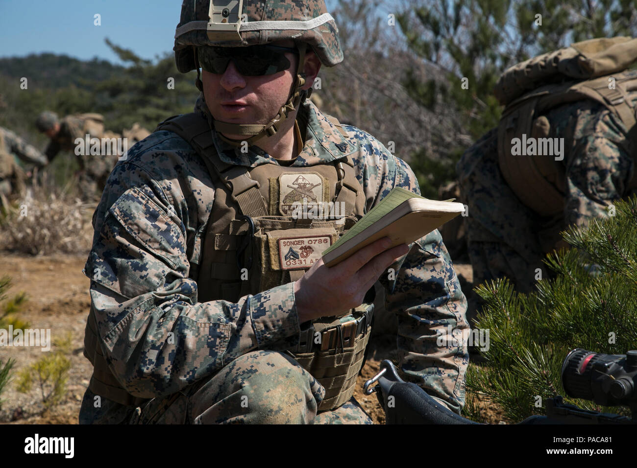 U.S. Marine Cpl. Scott Songer with Victor Unit 1/3, relays grid ...