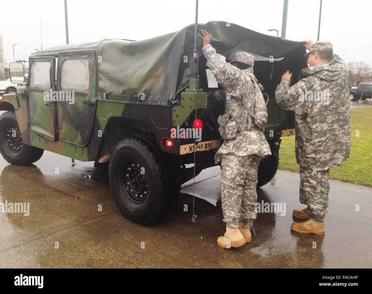 Members of the 890th Engineer Battalion in Gulfport, Miss., load up ...