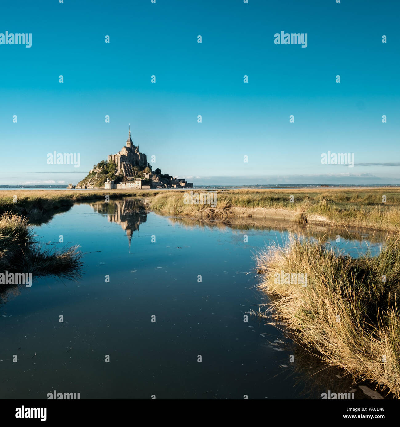 Famous Mont Saint-Michel reflected in evening light Stock Photo - Alamy
