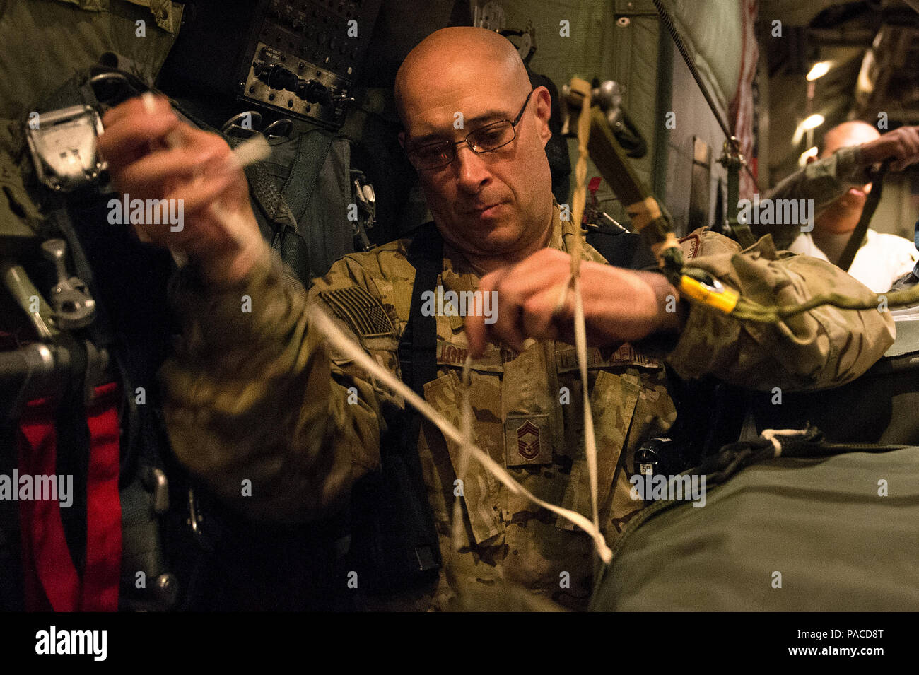 U.S. Air Force Chief Master Sgt. Jeffrey, 746th Expeditionary Airlift Squadron loadmaster, rigs ...