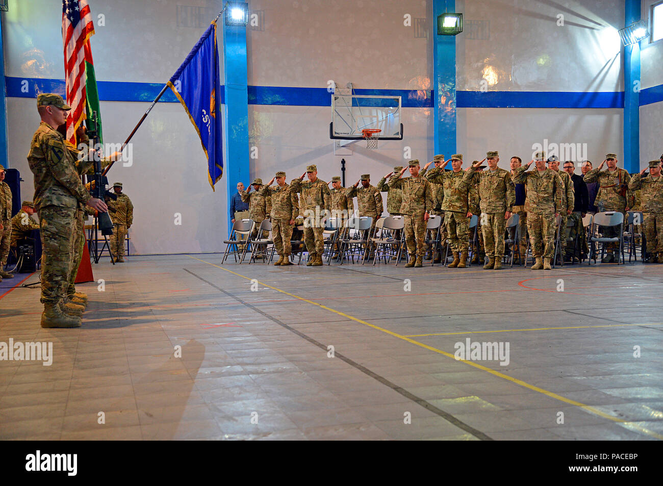 Military personnel salute the colors as the United States national ...