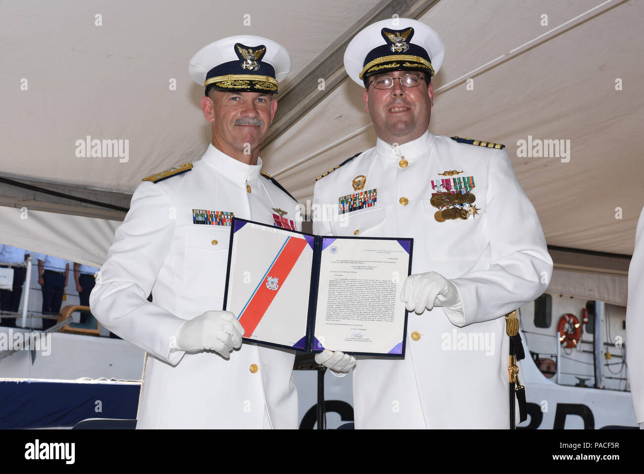 Vice Adm. Charles W. Ray, commander, Coast Guard Pacific Area, presents ...