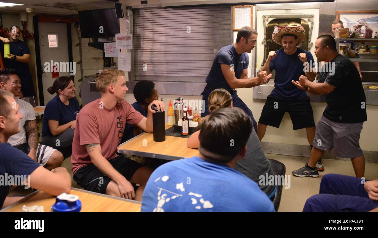 Crewmembers participate in a rock, paper, scissors tournament on the ...