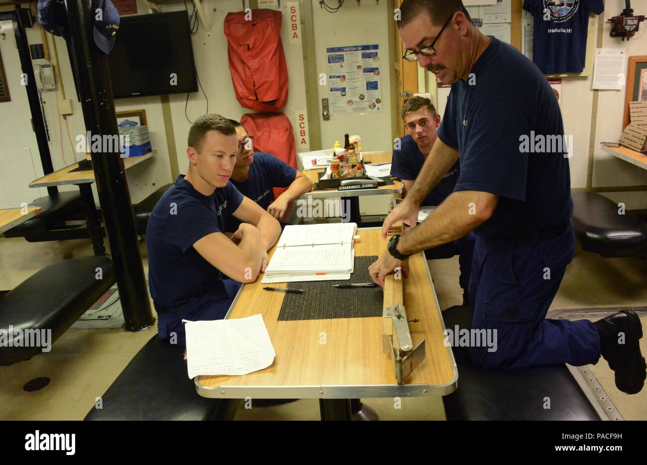 Petty Officer 1st Class Kevin Kalen, a damage controlman, gives shoring ...