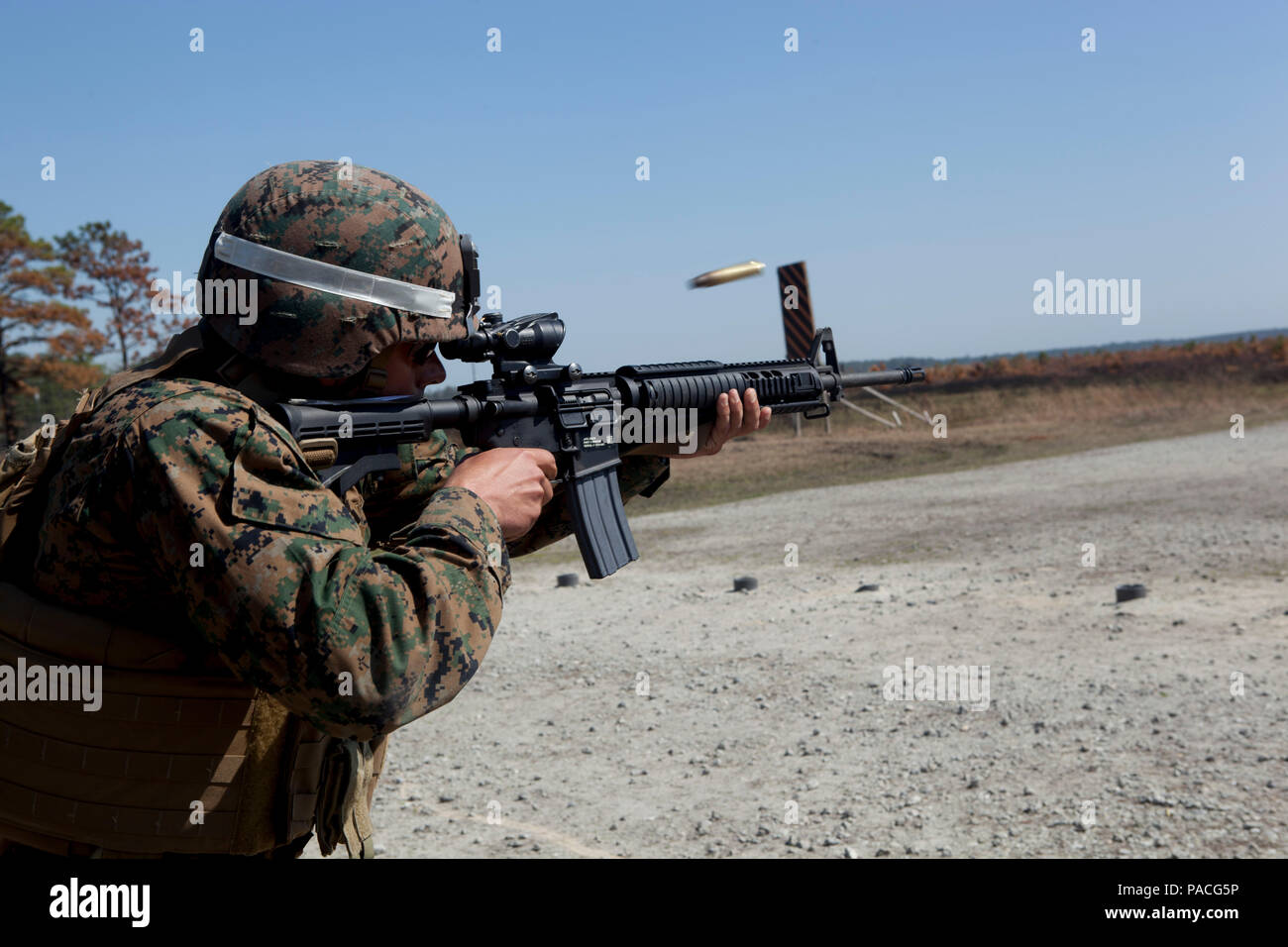 A U.S. Marine with the School of Infantry-East,fires his M16A4 service ...
