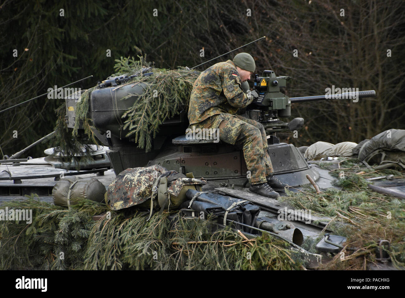 A German Soldier from the 131st German Artillery Battalion goes over ...
