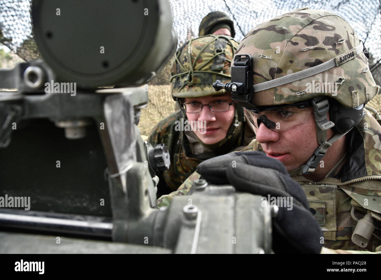 Spc. Julio Guerra (right,) a cannon crewmember assigned to Archer ...