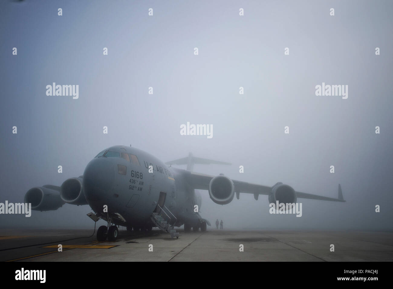 On a foggy flightline, Tech. Sgt. Christine King (right), 512th Airlift ...