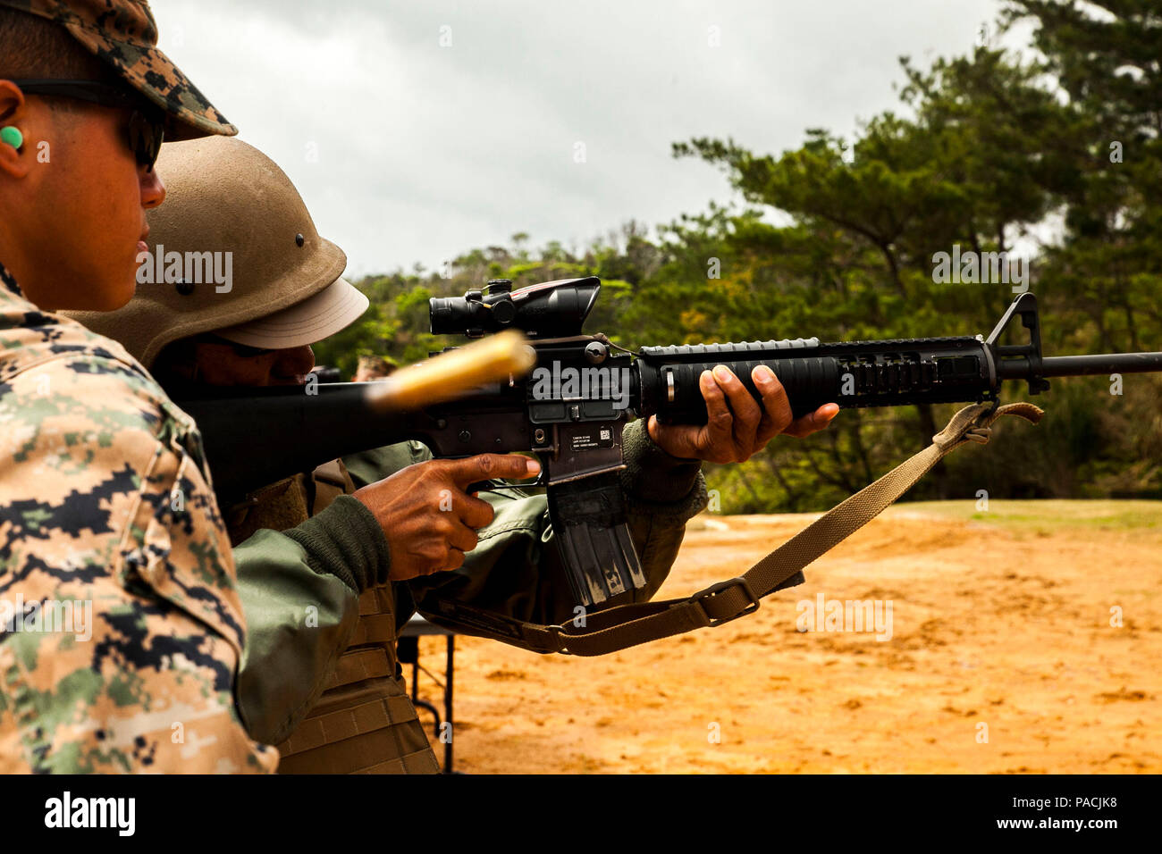 David Lucar fires an M16-A4 service rifle at Camp Schwab, Okinawa ...