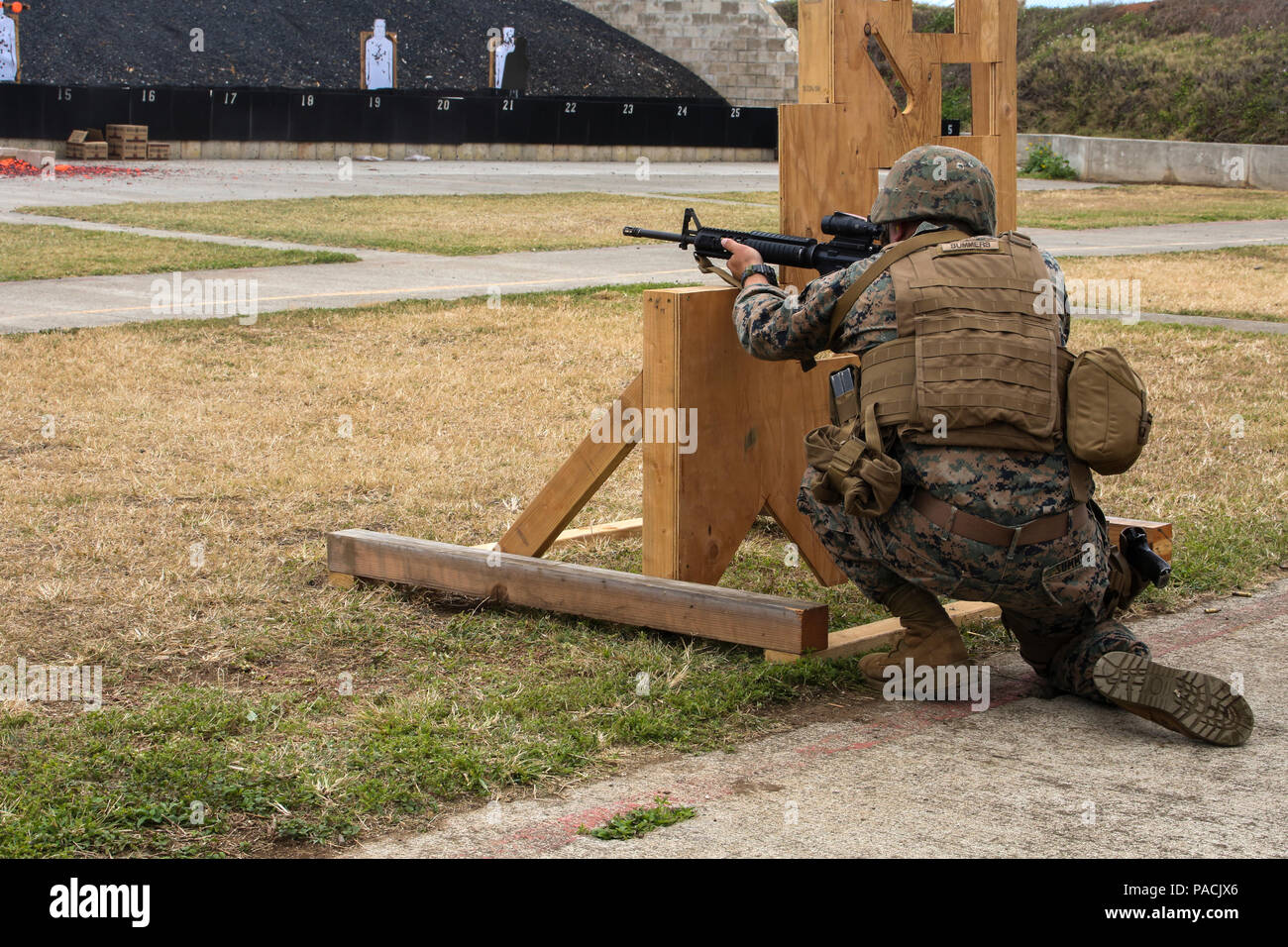 Cpl. Zachary Summers, a radio operator with 3rd Radio Battalion, kneels ...